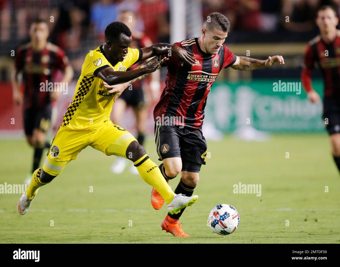 Atlanta United defender Greg Garza (4) is challenged by Columbus Crew ...