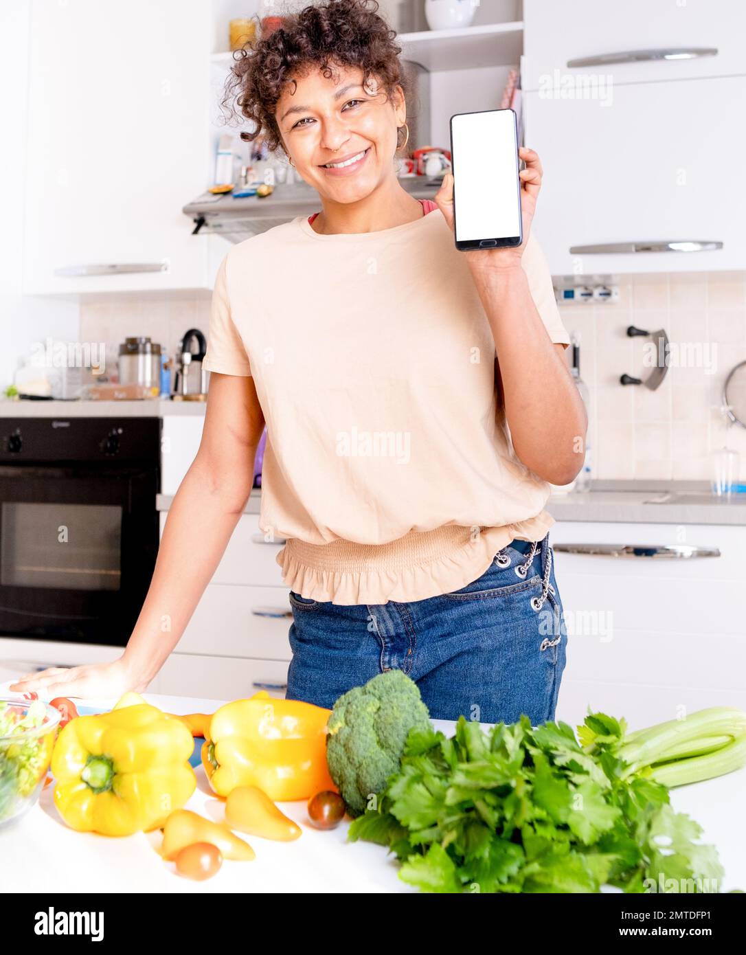 African in kitchen with phone hi-res stock photography and images - Alamy