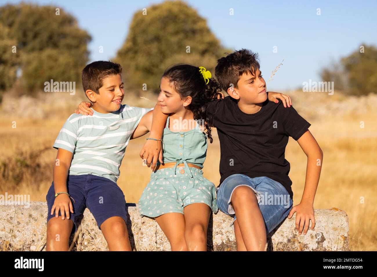 Three children enjoying their summer vacation in the countryside Stock ...