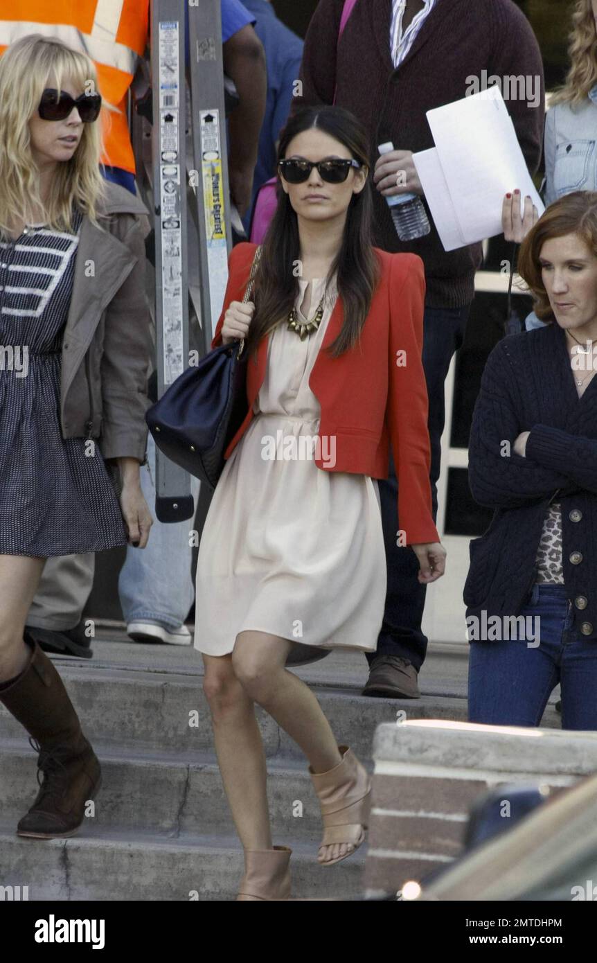 Wearing a red jacket and a simple white dress, actress Rachel Bilson ...