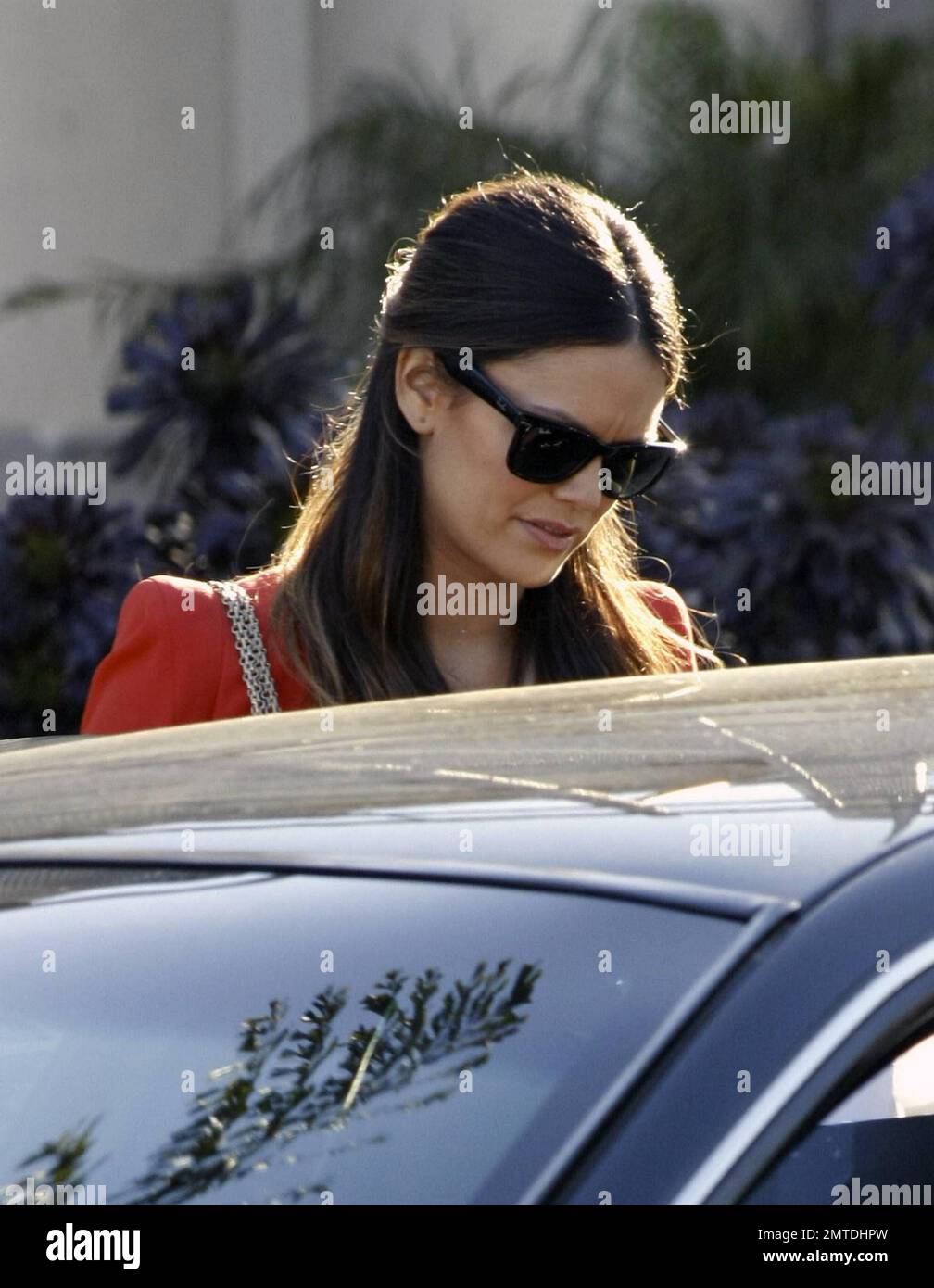 Wearing a red jacket and a simple white dress, actress Rachel Bilson ...