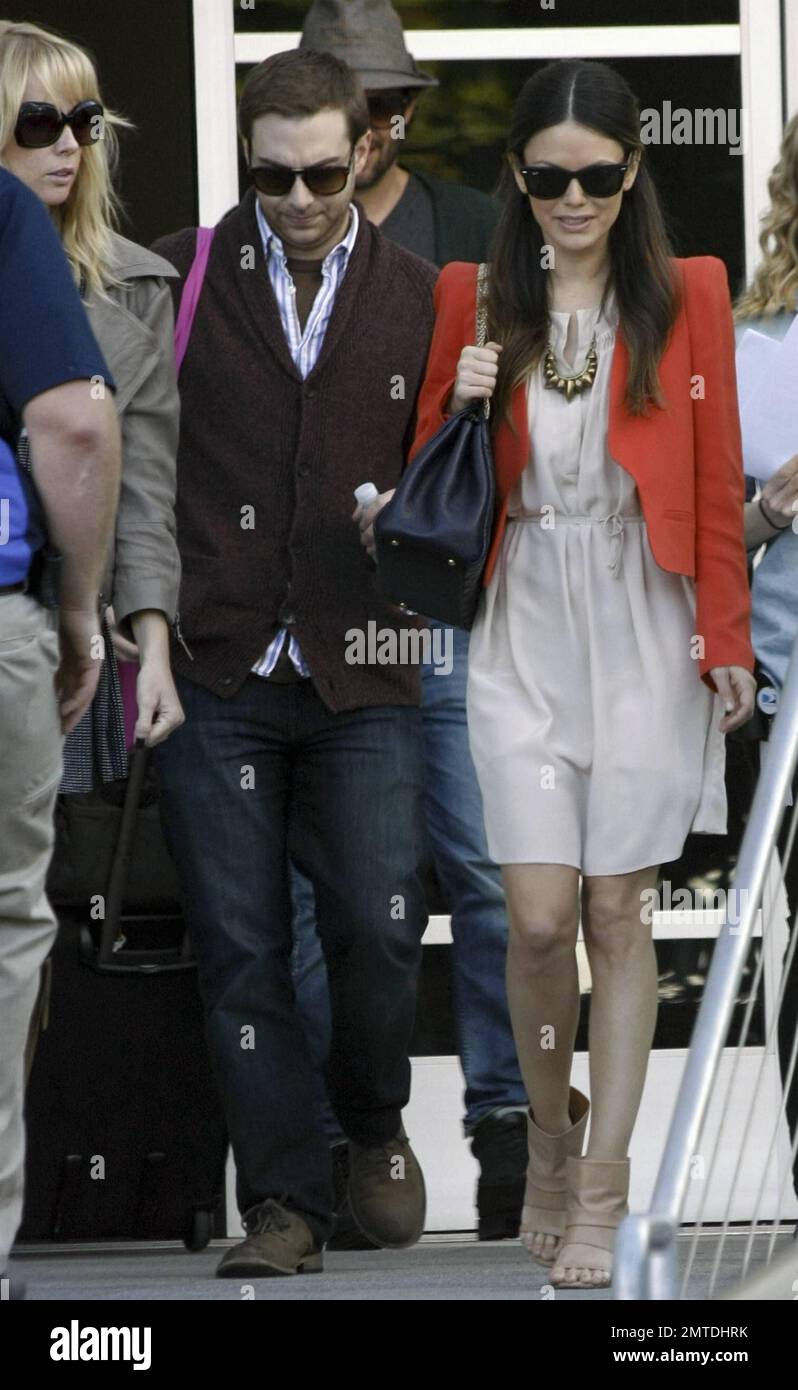 Wearing a red jacket and a simple white dress, actress Rachel Bilson ...