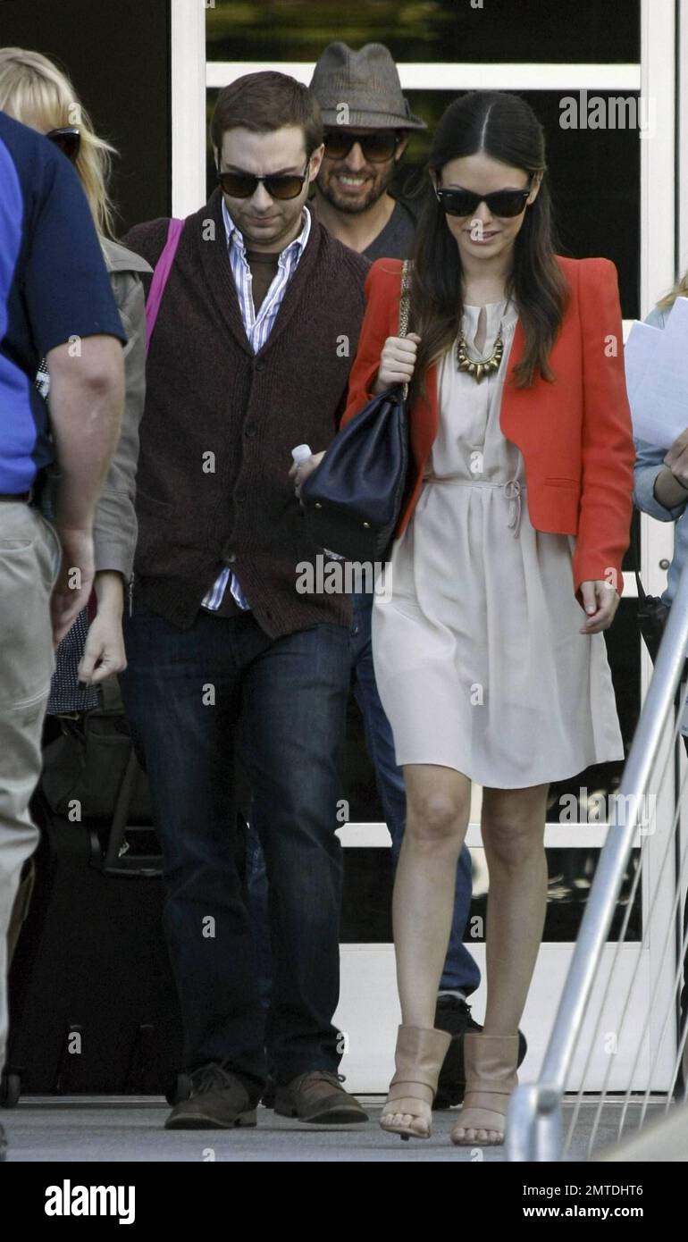 Wearing a red jacket and a simple white dress, actress Rachel Bilson ...