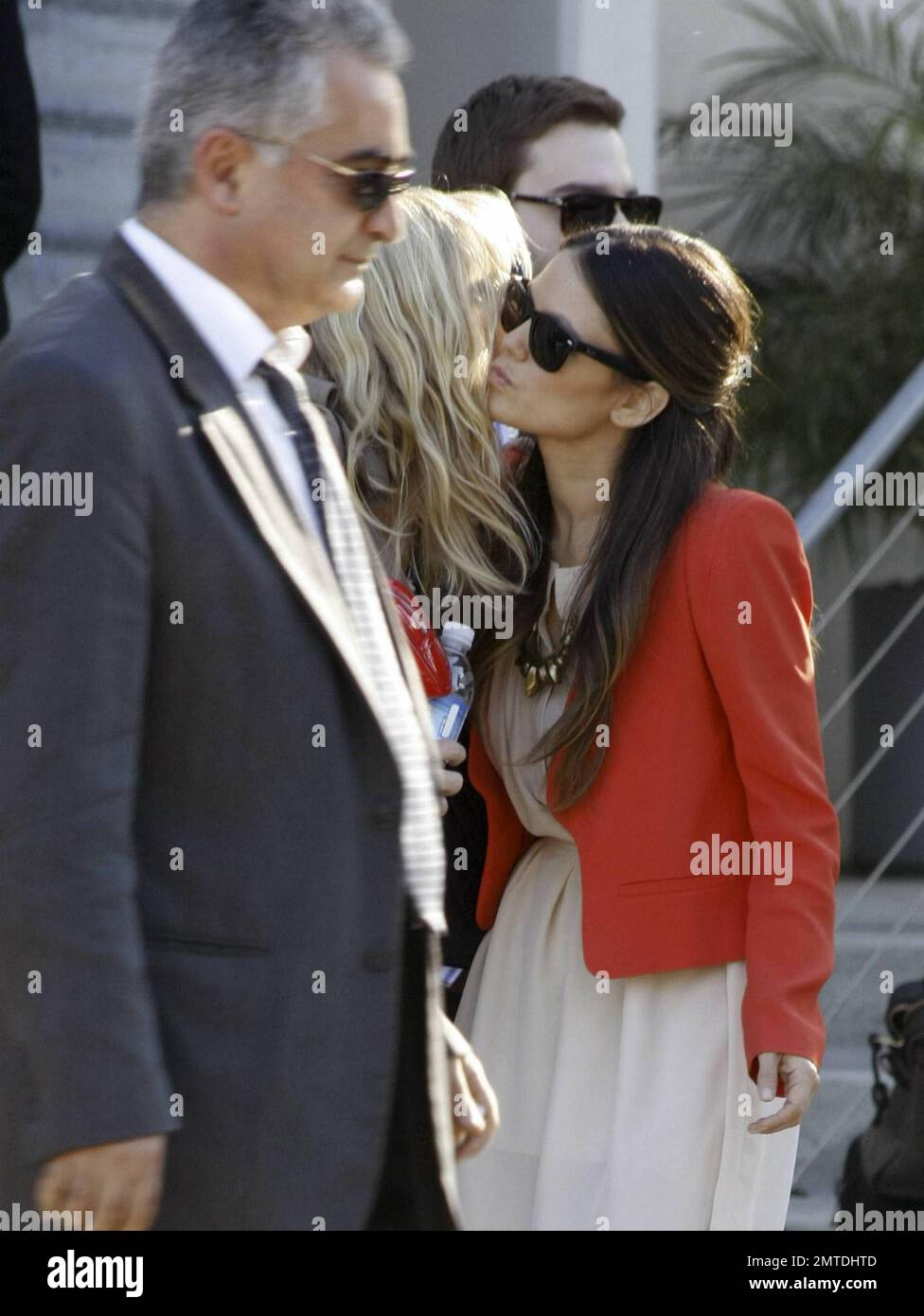 Wearing a red jacket and a simple white dress, actress Rachel Bilson ...