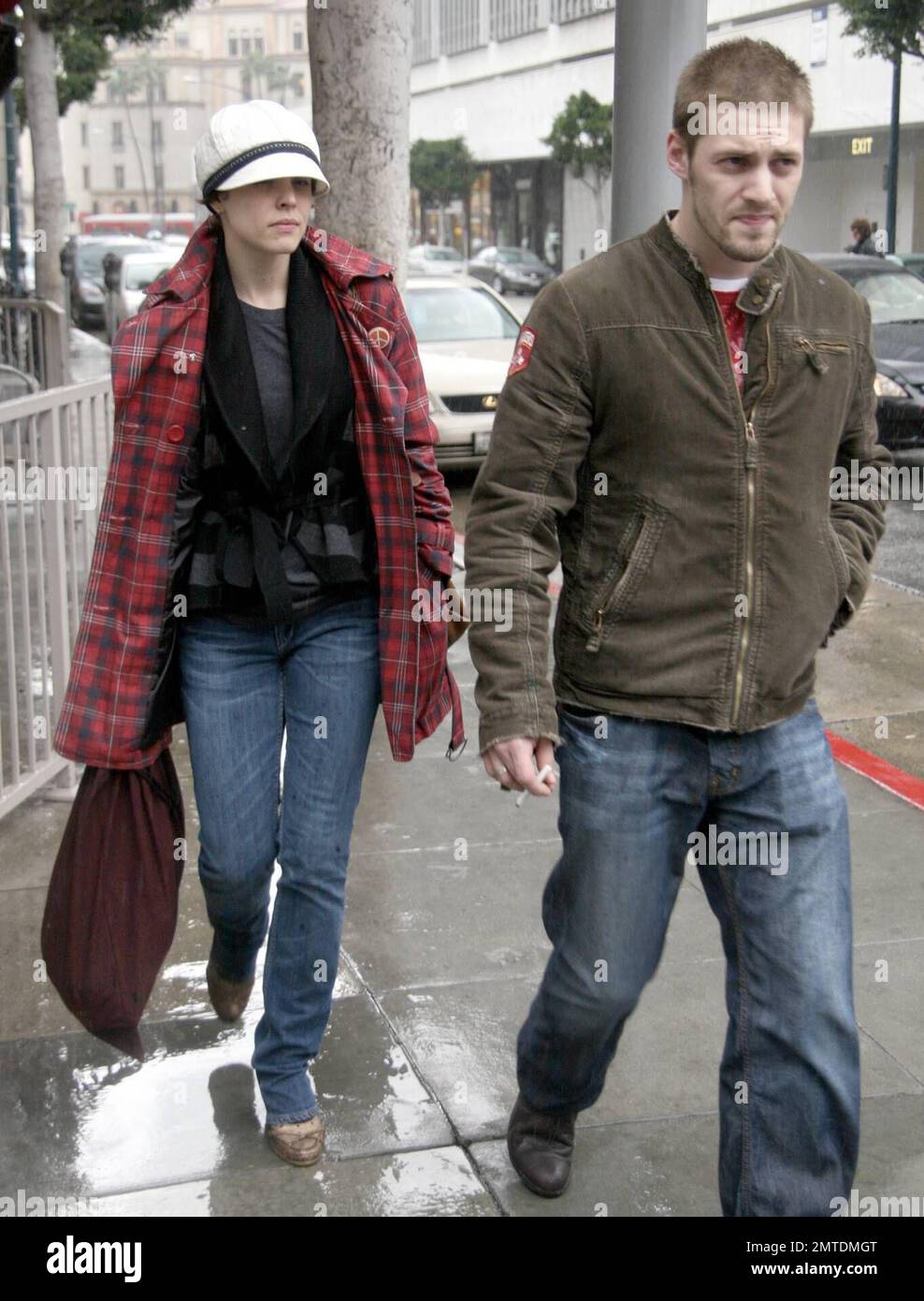 Rachel McAdams and a mystery man try to dodge rain drops and ...