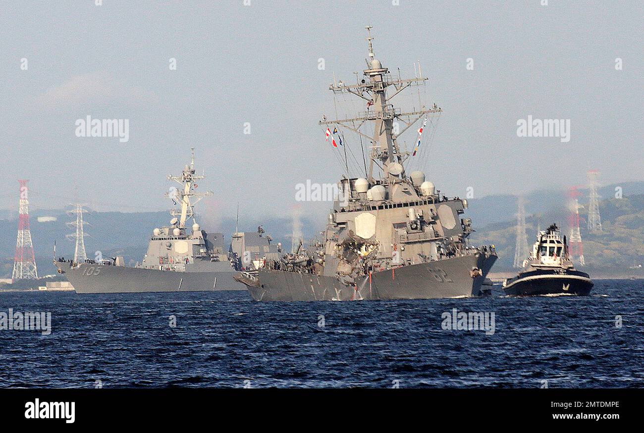 The damaged USS Fitzgerald, right, is seen near the U.S. Naval base in ...