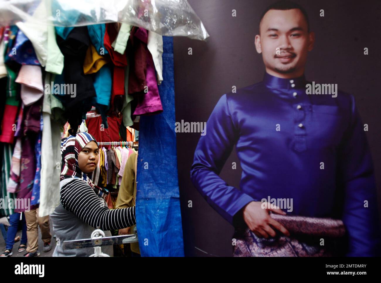 A Muslim woman shops for headscarves at a Ramadan bazaar in Kuala ...