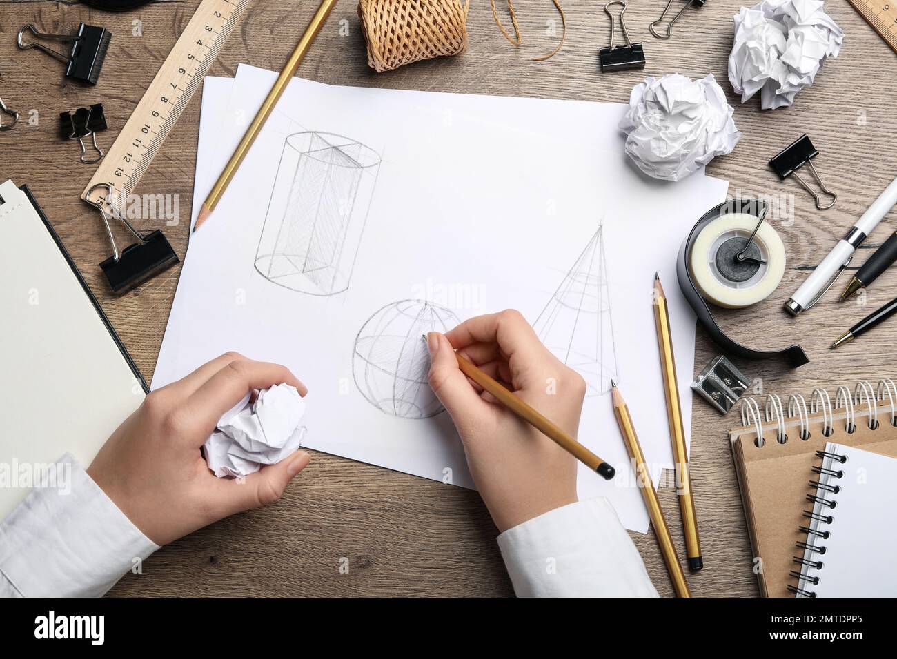 Graphic designer drawing geometry shapes at wooden table, top view ...