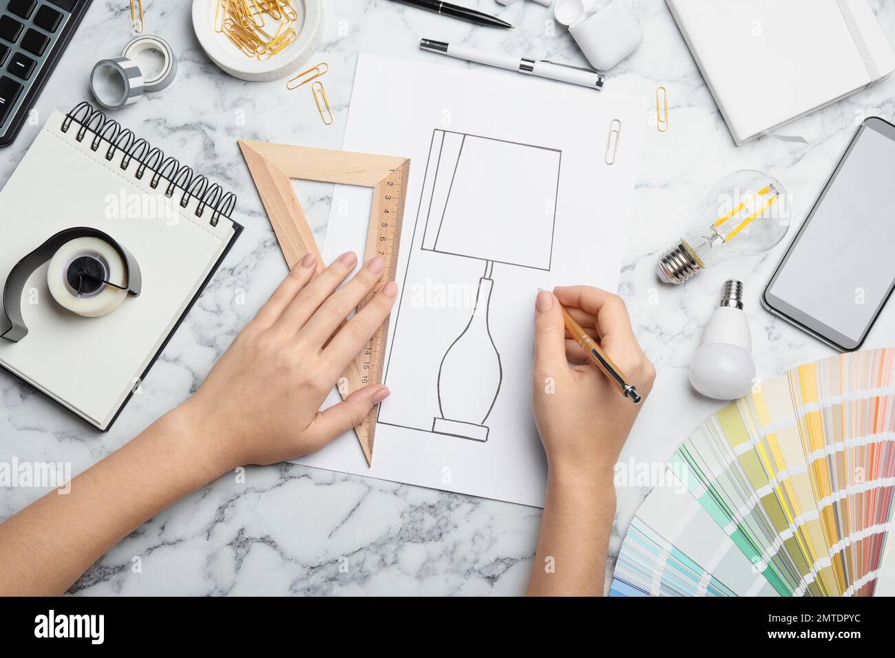 Designer drawing lamp at white marble table, top view Stock Photo - Alamy