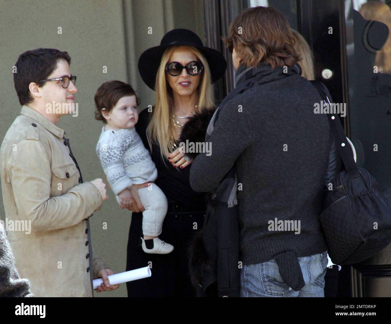 Fashion designer Rachel Zoe carries her son Skyler Morrison Berman as ...