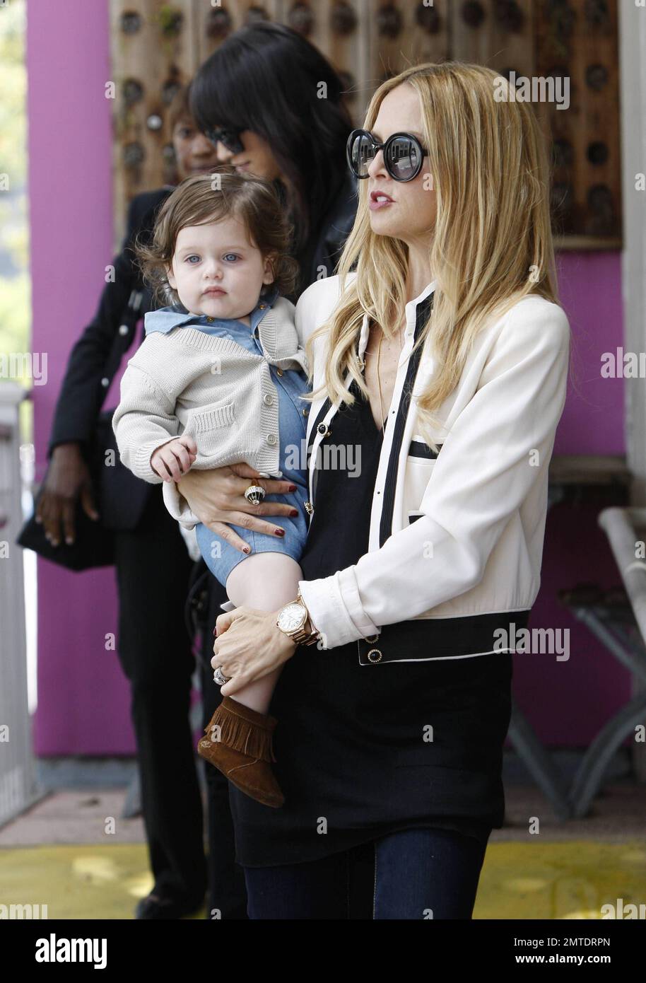 Wearing a white jacket with black trim paired with a black top and ...