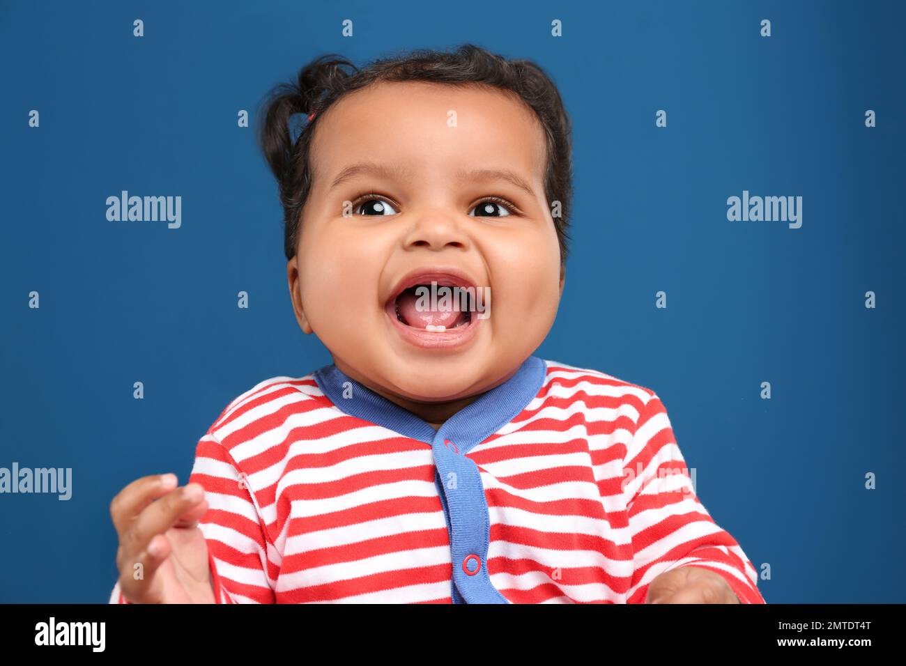 Cute African American baby on blue background Stock Photo - Alamy
