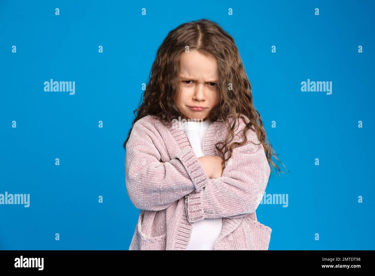 Portrait of cute little girl on light blue background Stock Photo - Alamy