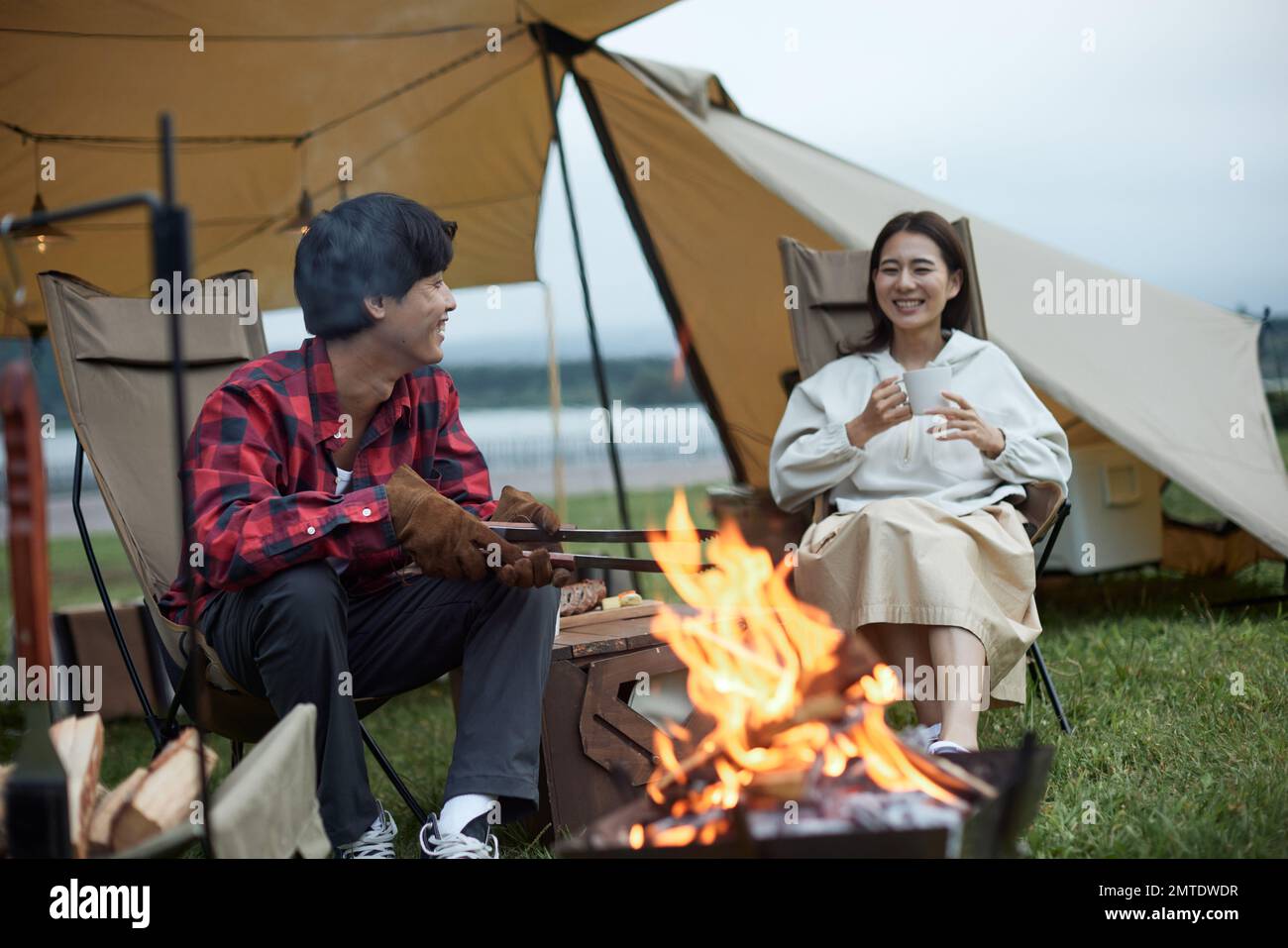 Young couple camping drinking hi-res stock photography and images - Alamy