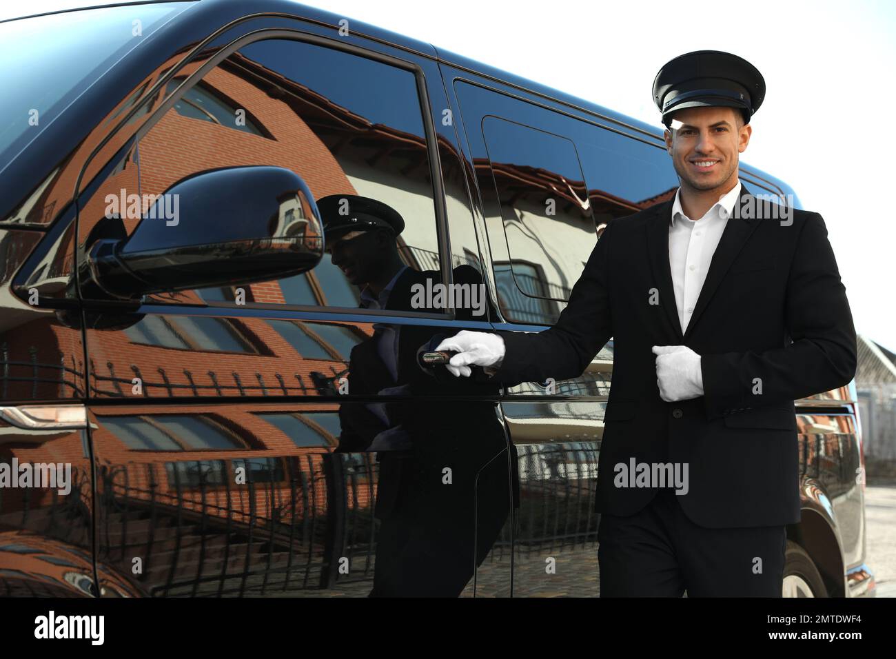 Professional driver near luxury car. Chauffeur service Stock Photo - Alamy