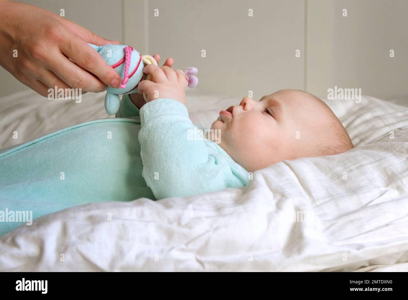 Cute Newborn Baby Lying on the Back and Plays with Colorful Toys ...