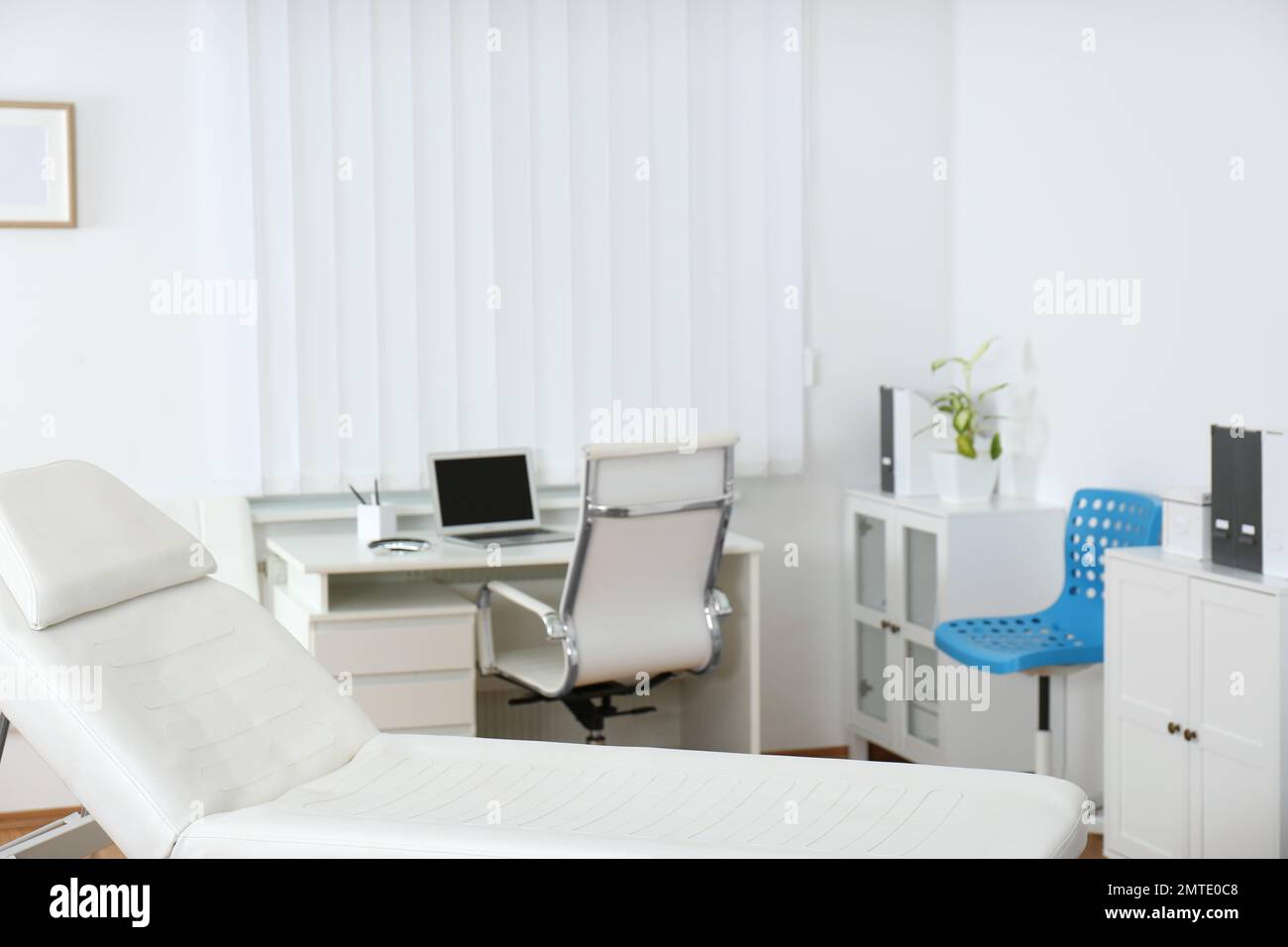 Modern medical examination couch in doctor's office Stock Photo - Alamy