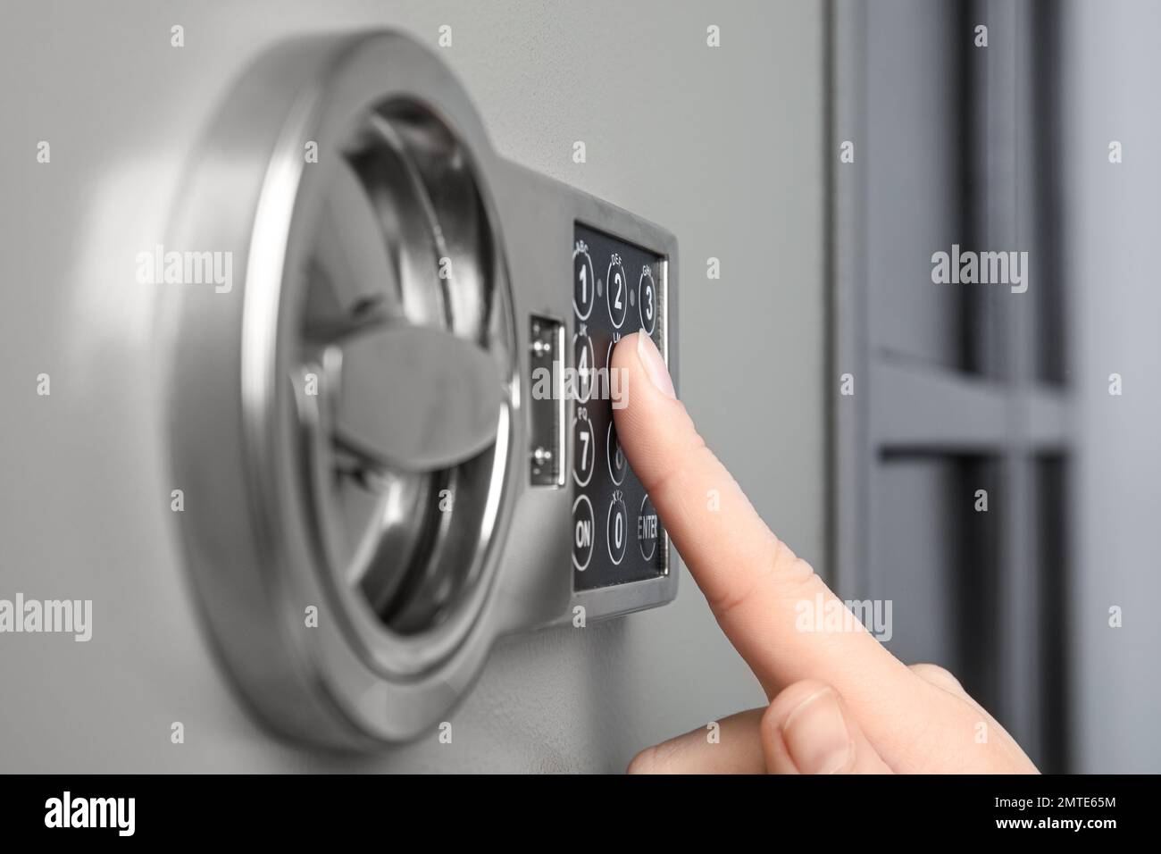 Woman opening steel safe hi-res stock photography and images - Alamy
