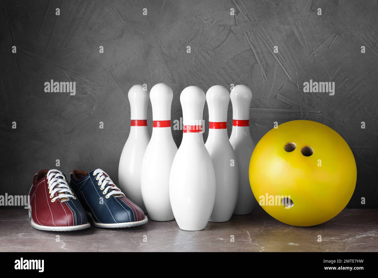 Bowling shoes, pins and ball on grey marble table Stock Photo - Alamy