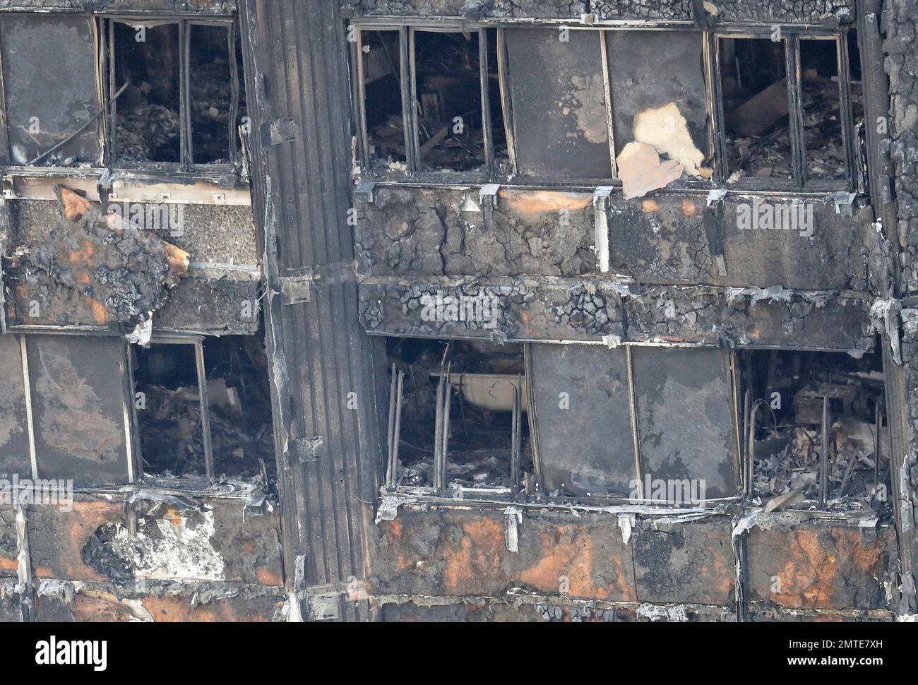 Part of the scorched facade of the Grenfell Tower in London as ...