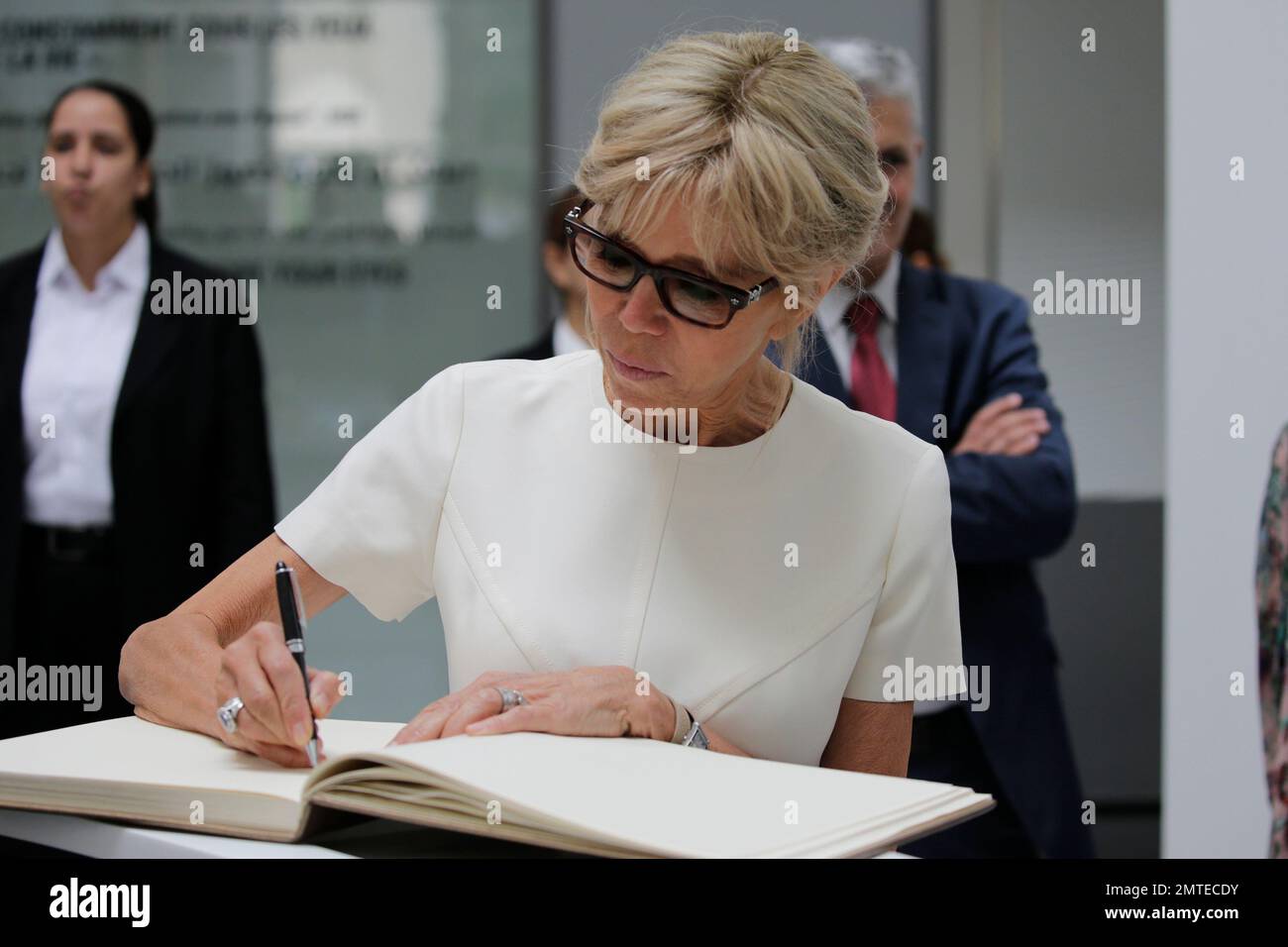 French first lady Brigitte Macron signs the golden book during a visit ...