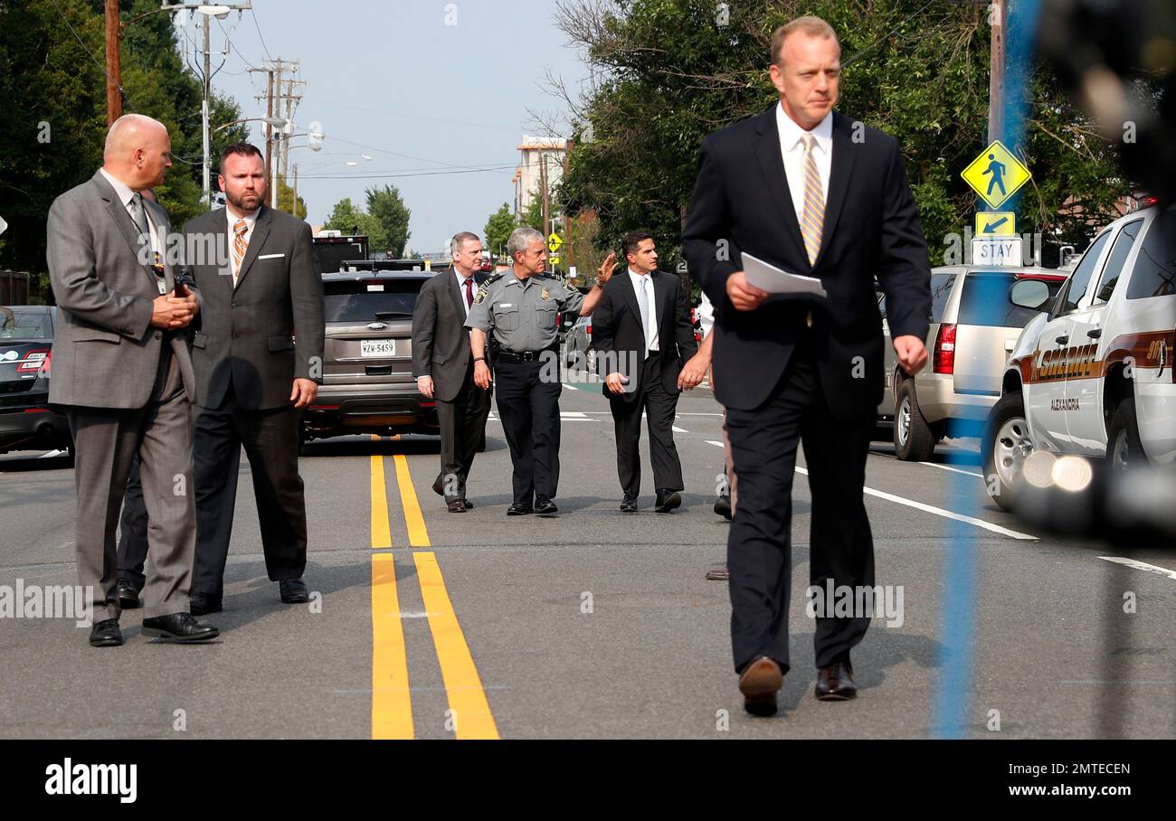 FBI Special Agent in Charge Tim Slater, right, walks to the microphones ...