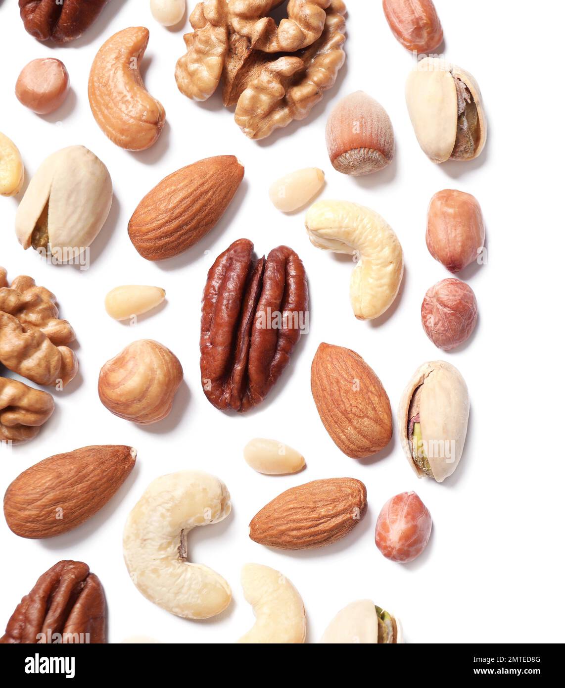 Different delicious nuts on white background, flat lay. Space for text ...