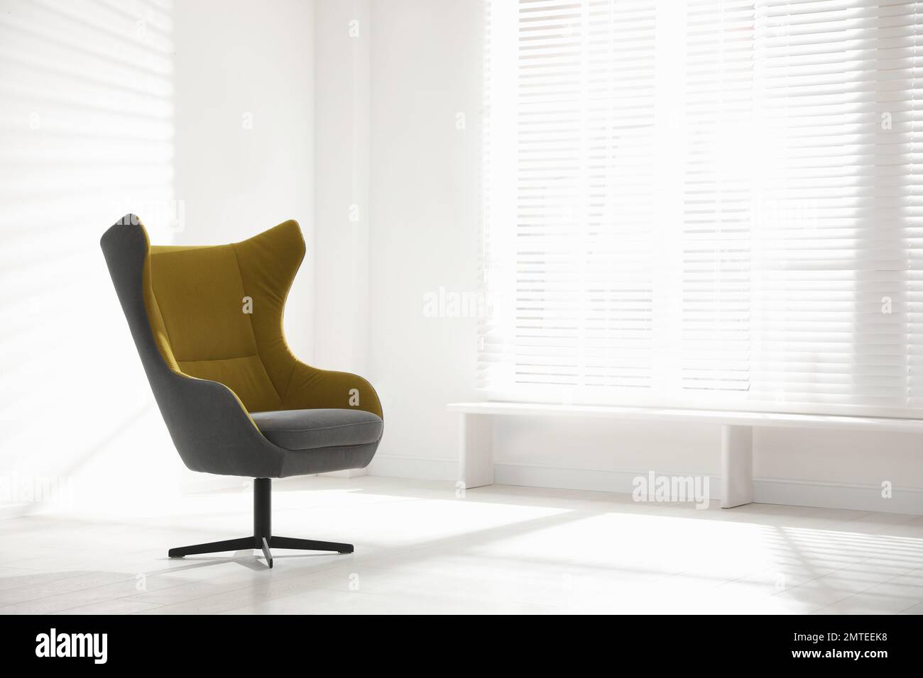 Modern armchair near window in light room Stock Photo - Alamy