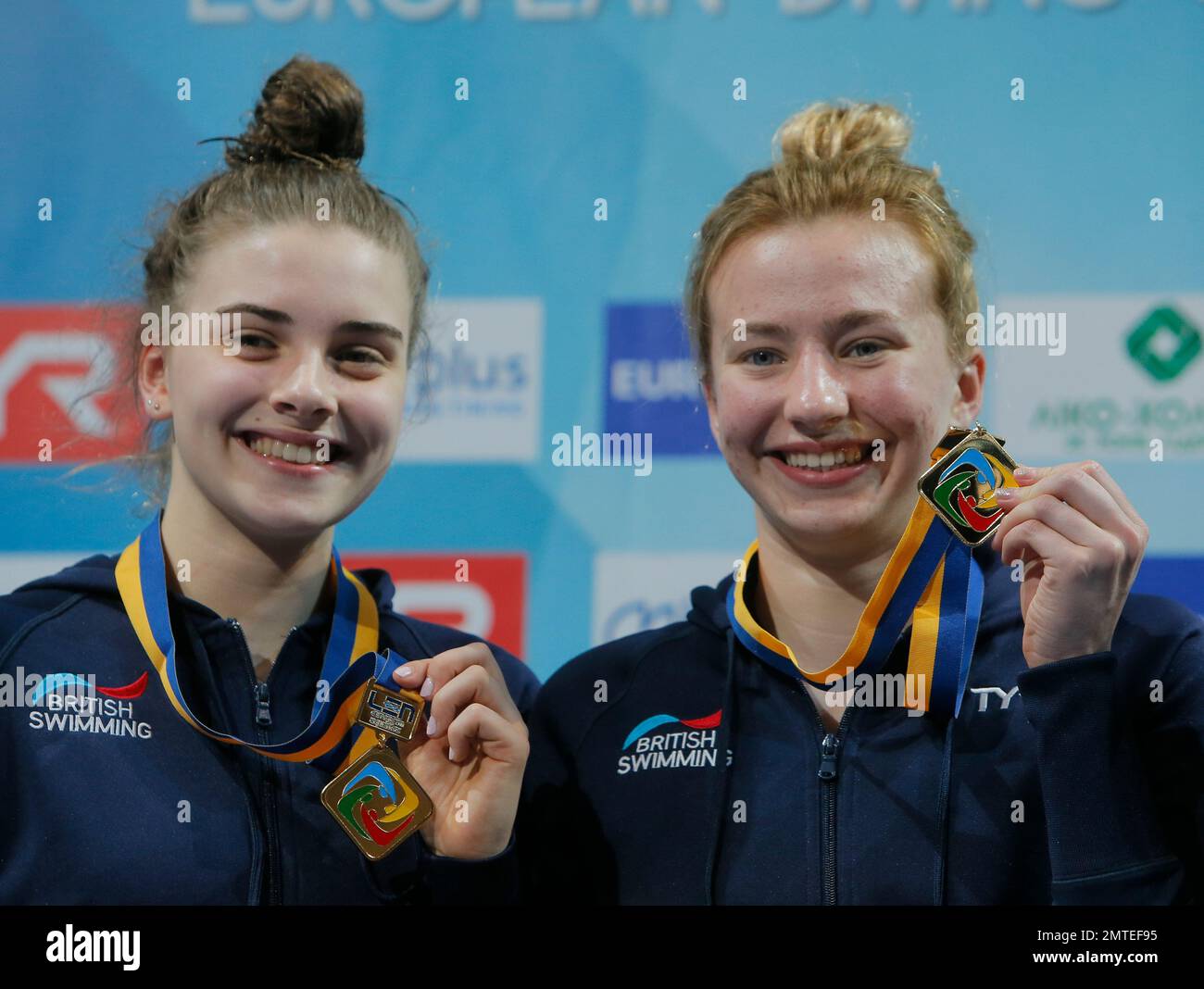 Britain's Phoebe Banks, right, and Ruby Bower hold up their gold medals ...