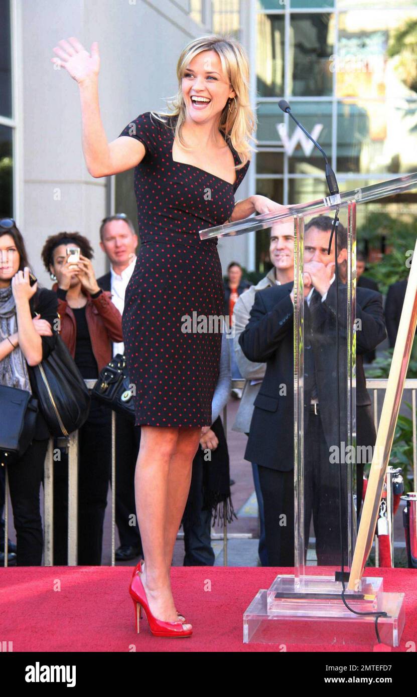 Clad in a classic polka dot afternoon dress and cherry red high heels ...