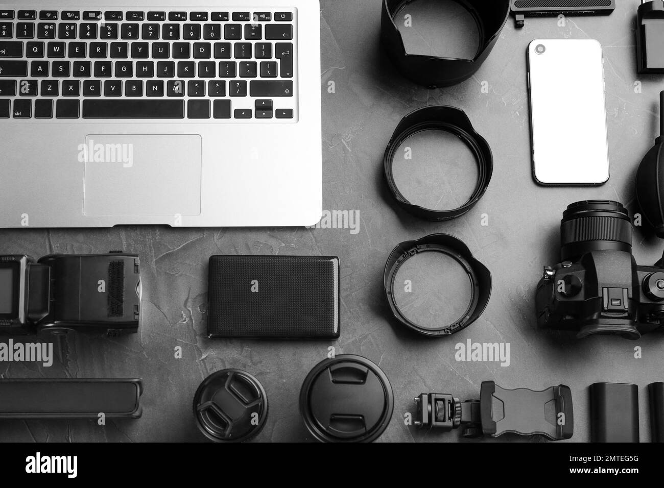 Flat lay composition with camera and video production equipment on grey ...