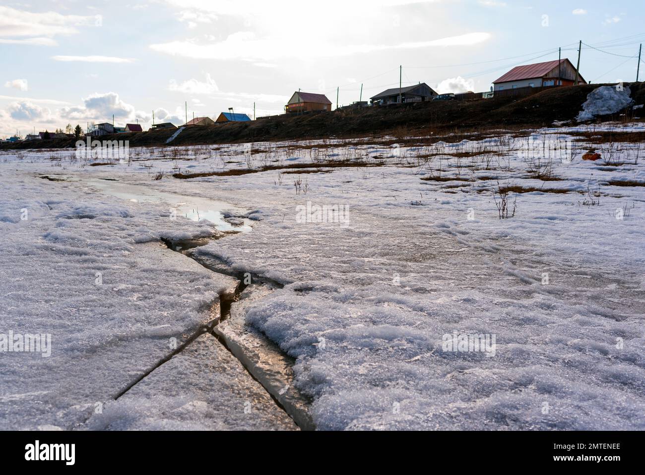 Spring cracked ice on the shore near the ancient Suntar on the Vilyui ...