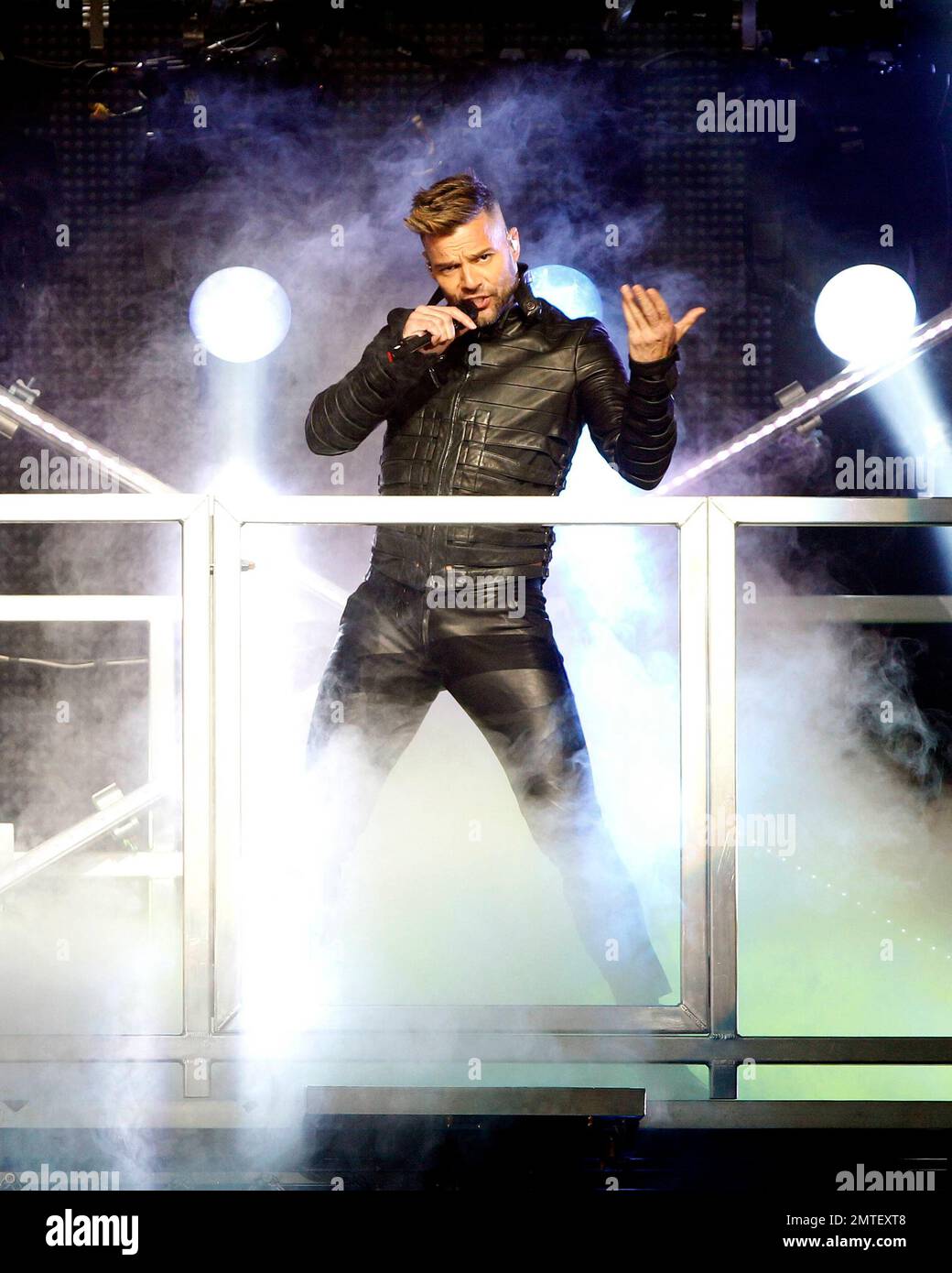 With his hair clipped short at the sides and left long at the top and ...