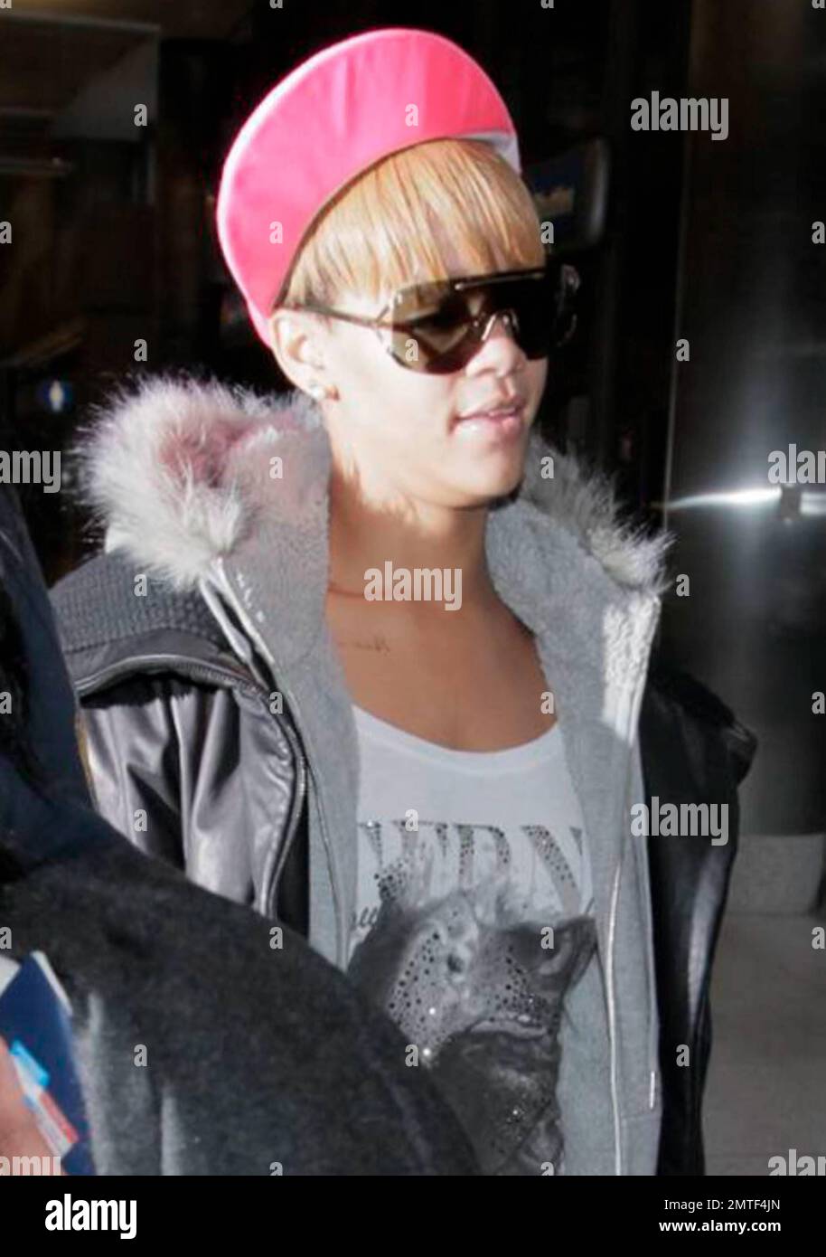 Rihanna arrives at LAX and walks to a waiting limo wearing a trendy ...
