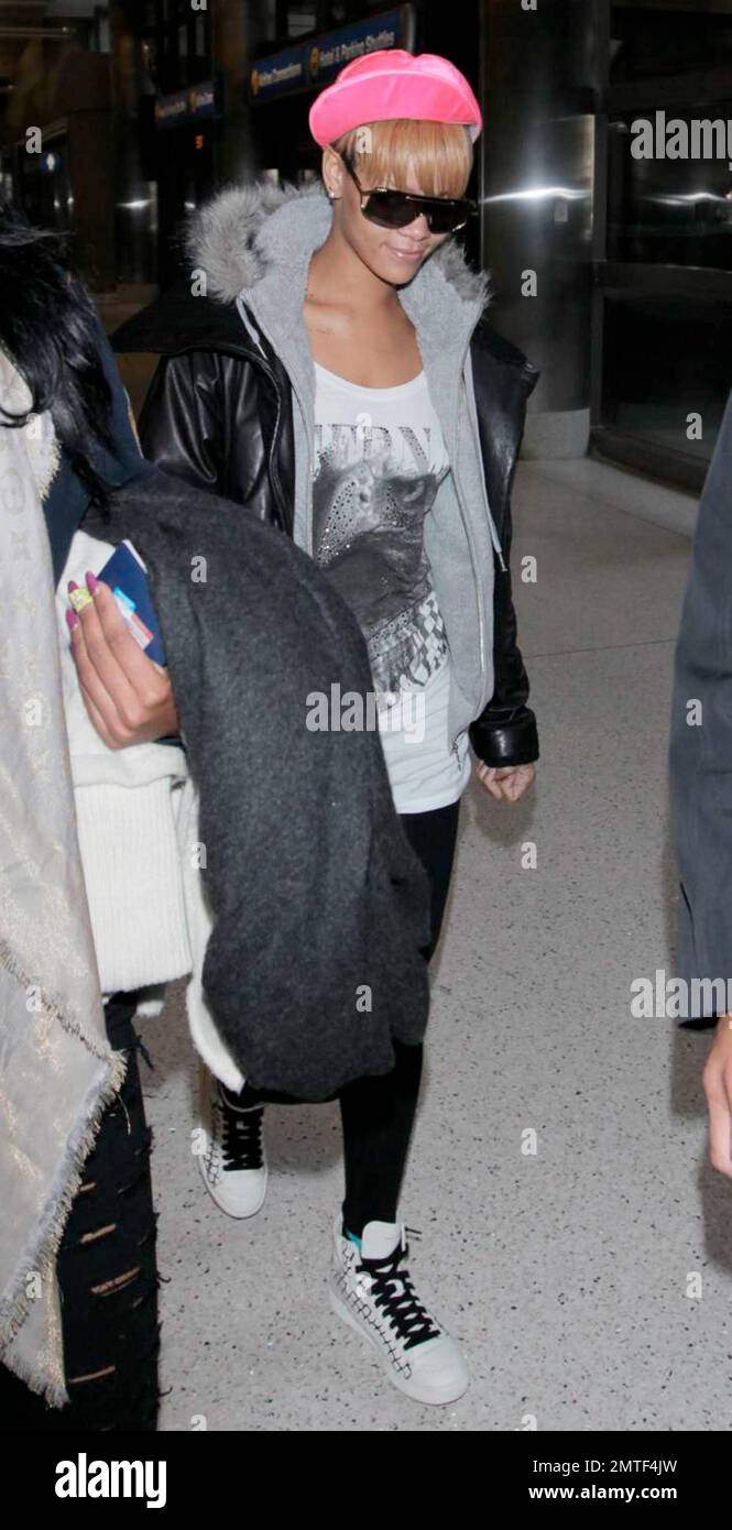 Rihanna arrives at LAX and walks to a waiting limo wearing a trendy ...