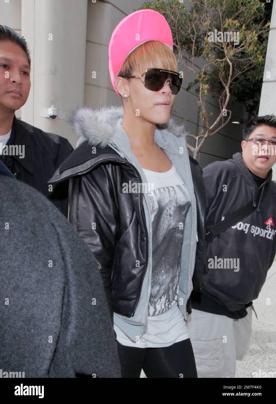 Rihanna arrives at LAX and walks to a waiting limo wearing a trendy ...
