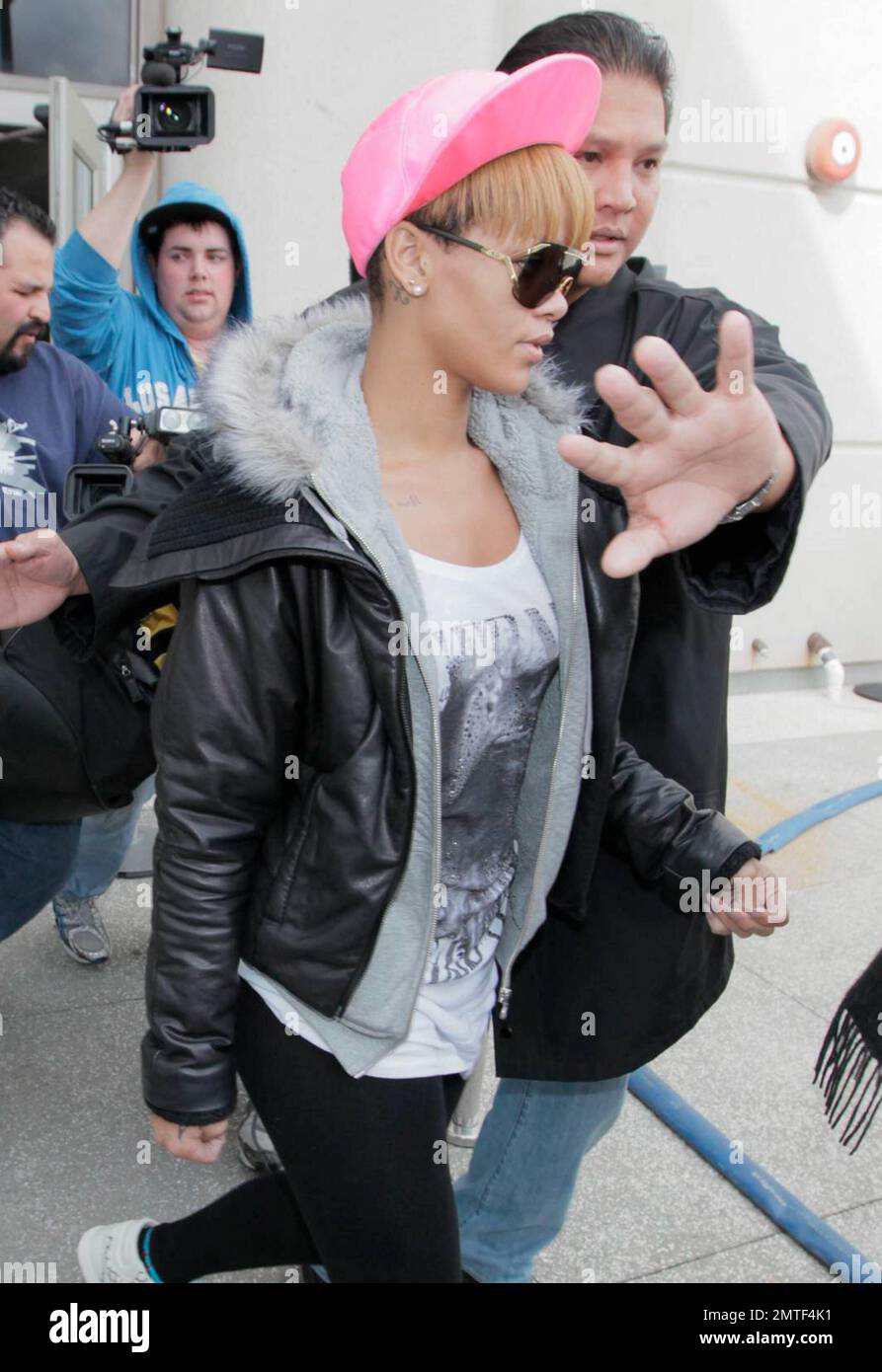 Rihanna arrives at LAX and walks to a waiting limo wearing a trendy ...