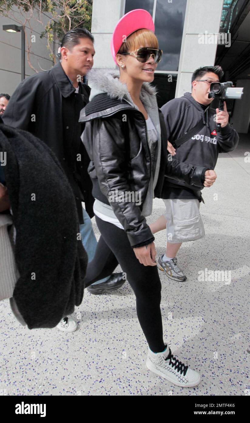 Rihanna arrives at LAX and walks to a waiting limo wearing a trendy ...