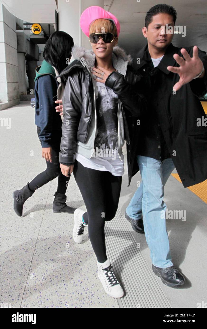 Rihanna arrives at LAX and walks to a waiting limo wearing a trendy ...
