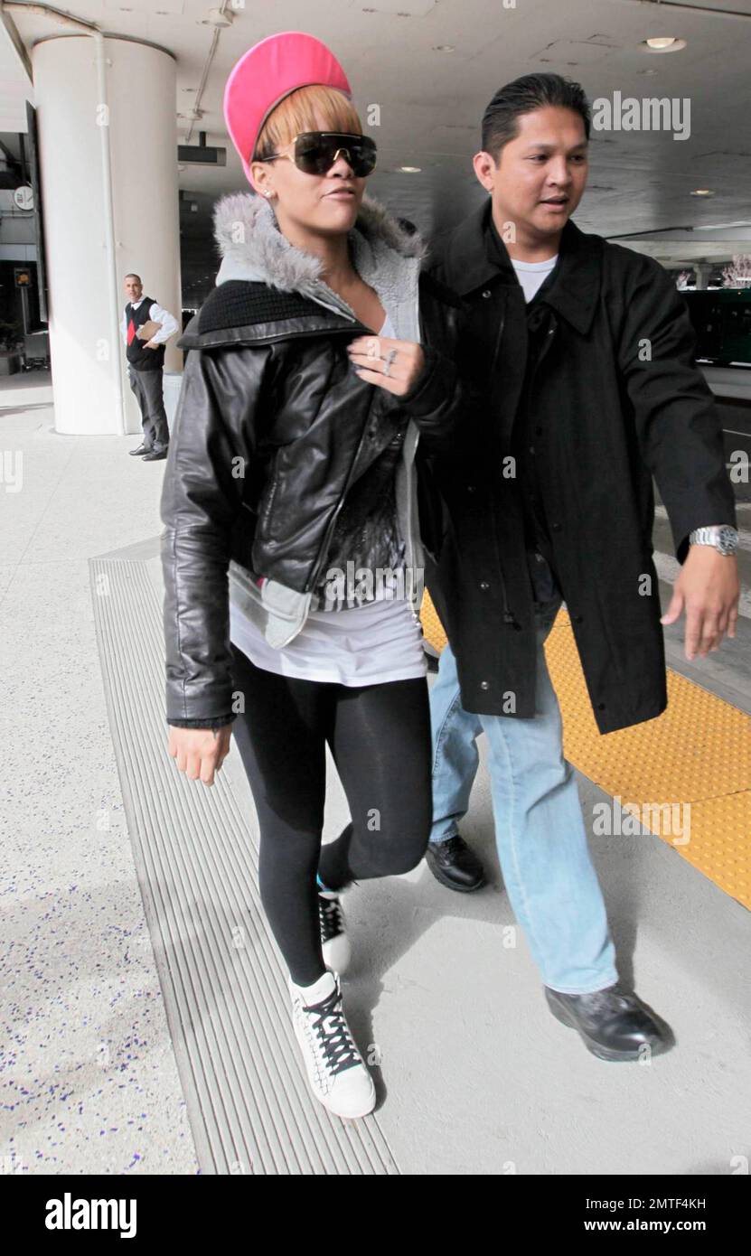 Rihanna arrives at LAX and walks to a waiting limo wearing a trendy ...