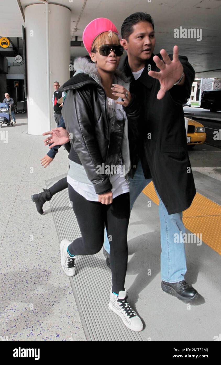 Rihanna arrives at LAX and walks to a waiting limo wearing a trendy ...