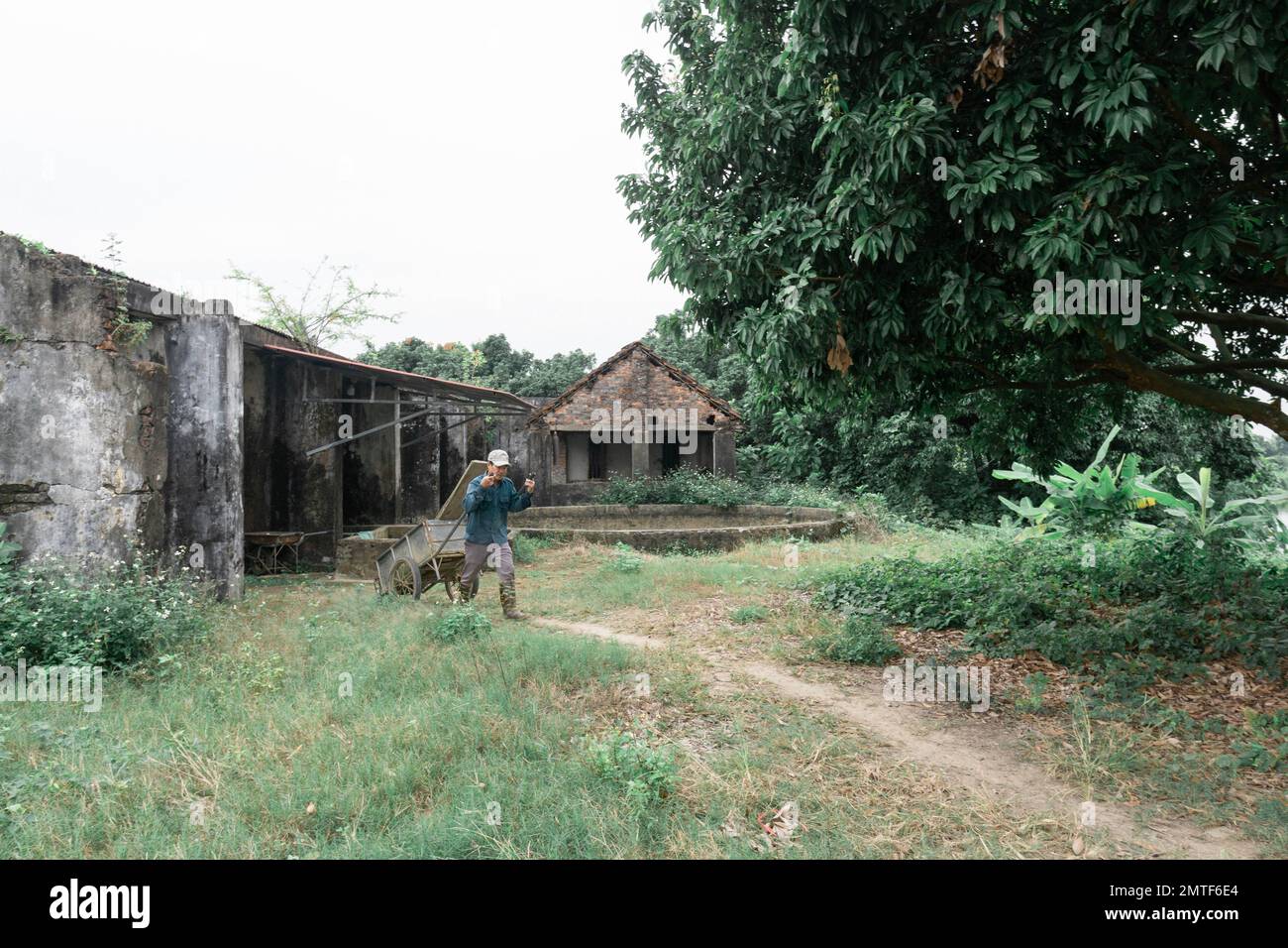 Man going out from a tent dragging a 2-wheel vehicle Stock Photo - Alamy