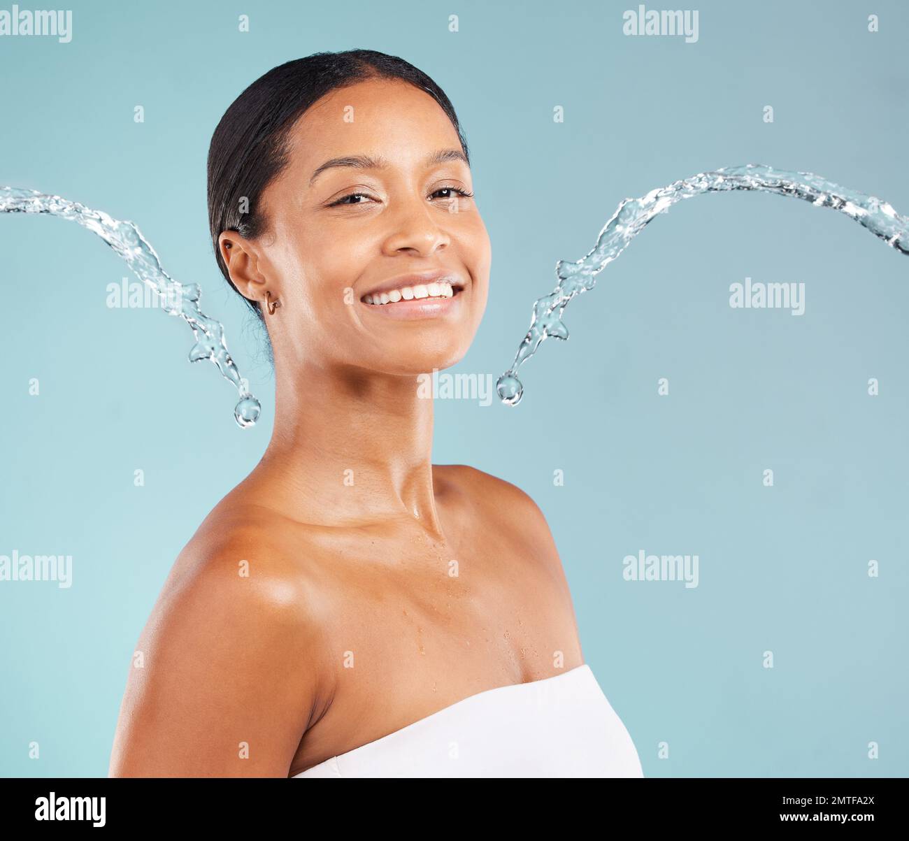 Black woman, portrait and skincare with water splash, blue background ...