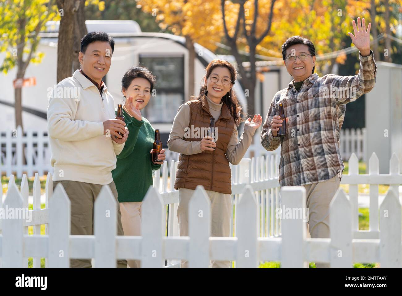 A group of old people standing in the rv campsite to drink beer Stock ...