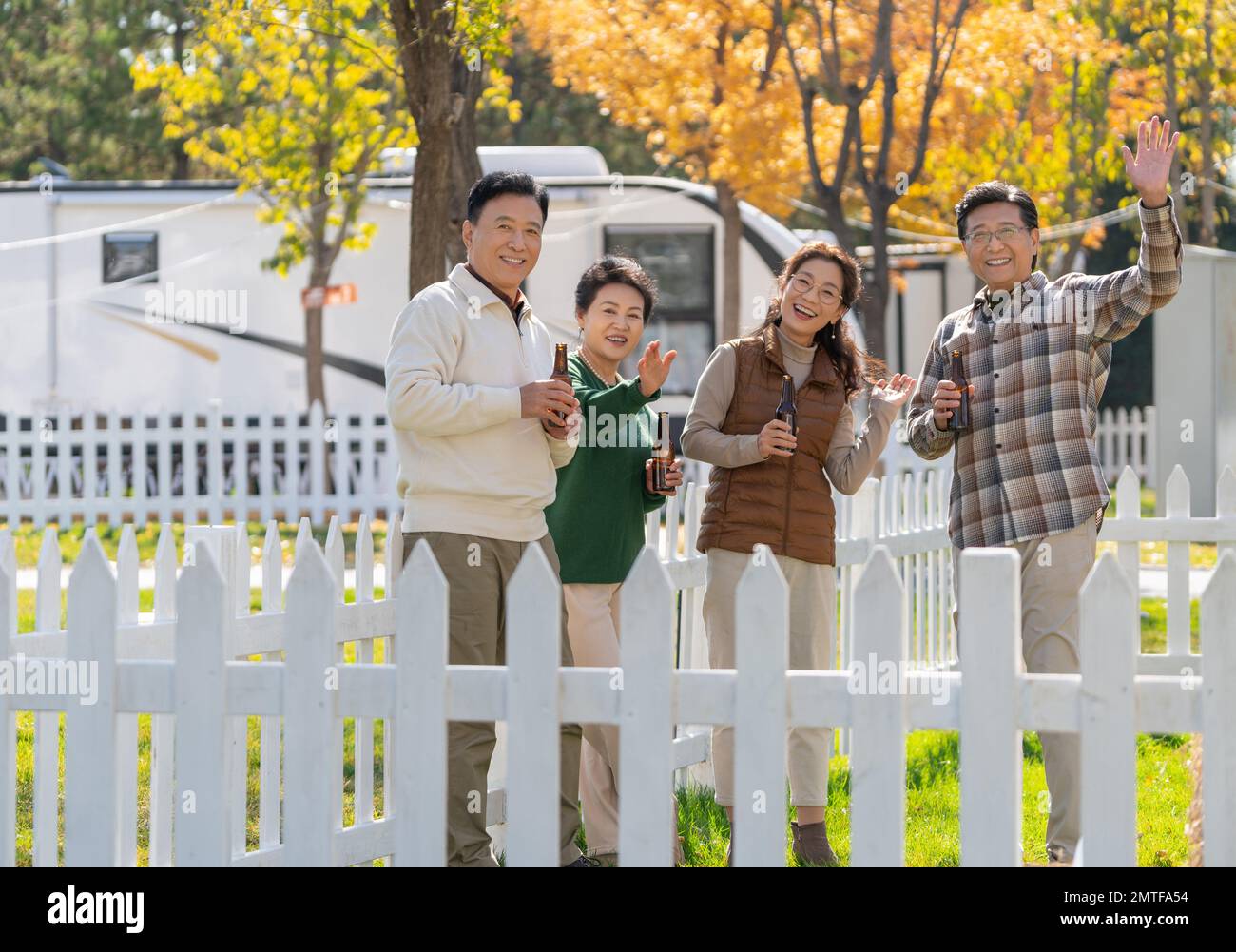 A group of old people standing in the rv campsite to drink beer Stock ...