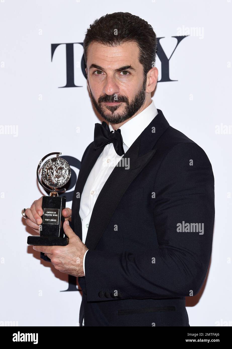 Michael Aronov poses in the press room with the award for best ...