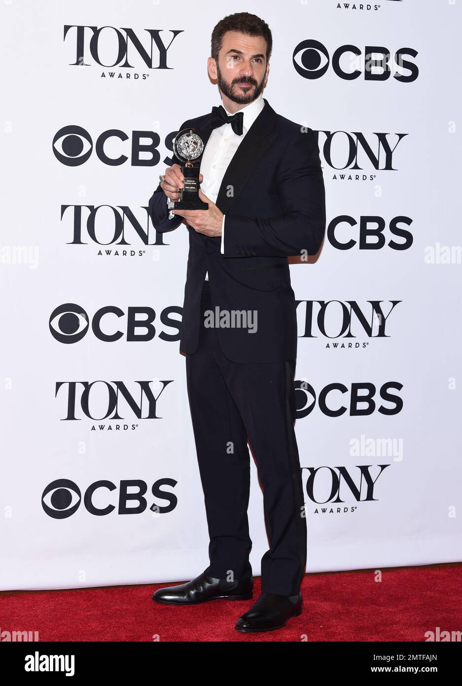 Michael Aronov poses in the press room with the award for best ...