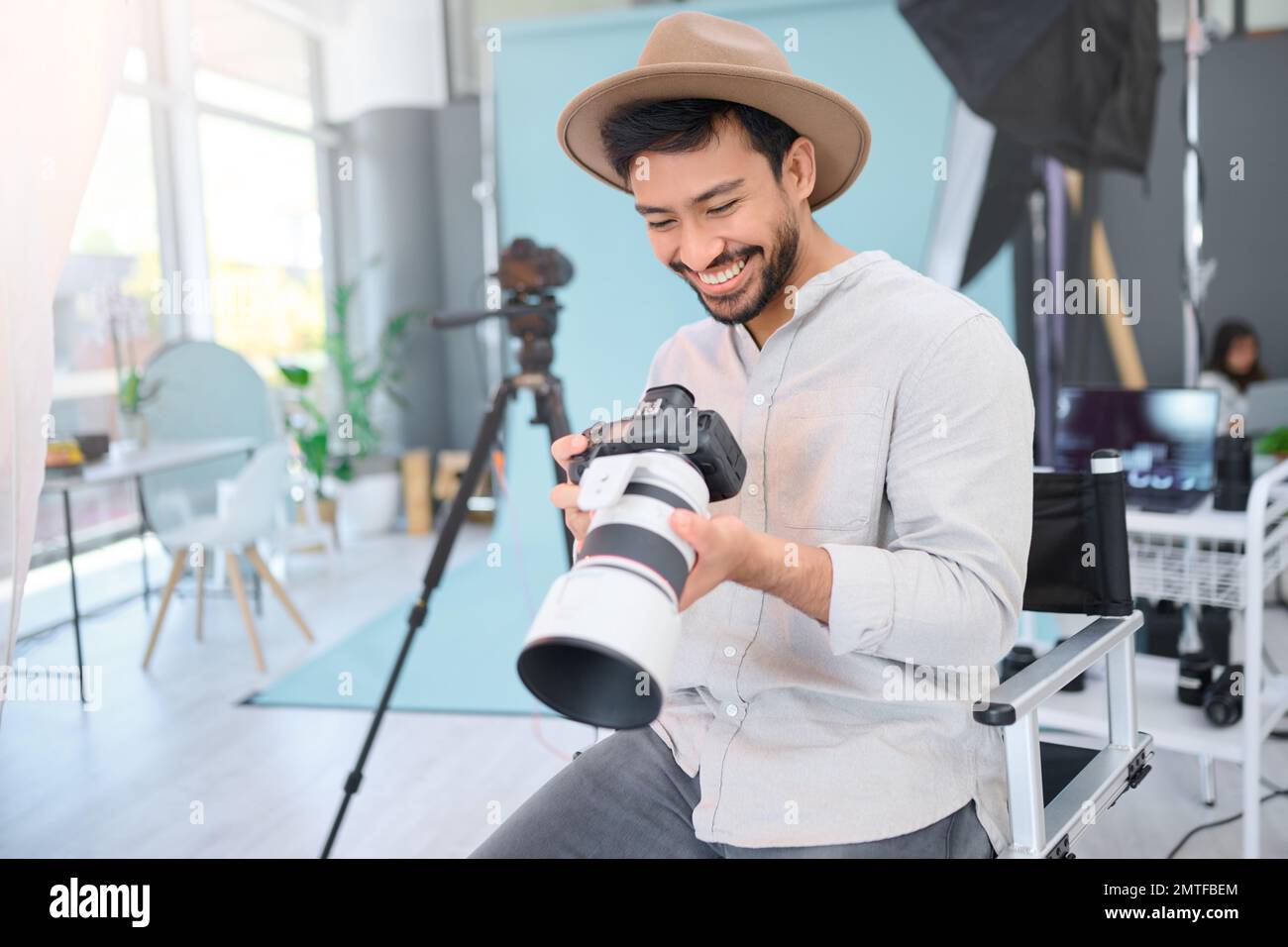 Happy, photographer and man with camera in studio, smile and excited ...