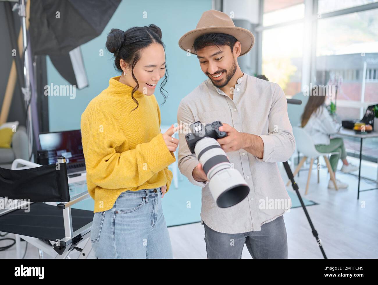 Camera, creativity and photographer talking to a model while looking at ...