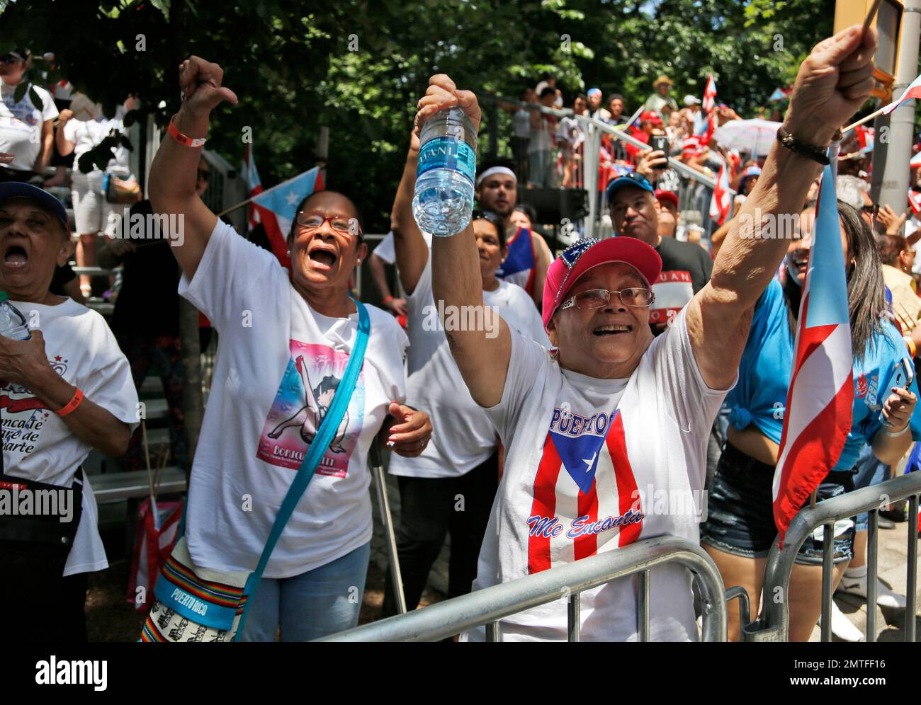 One woman celebrates as another gives a thumbs down as a float carrying ...